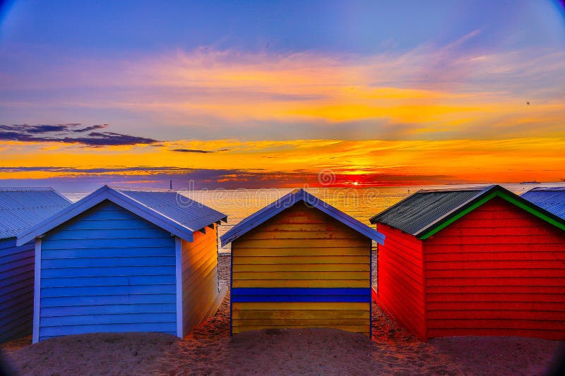 Colored Cabins on the Beach during the Yellow Sunset. Stock Photo ...