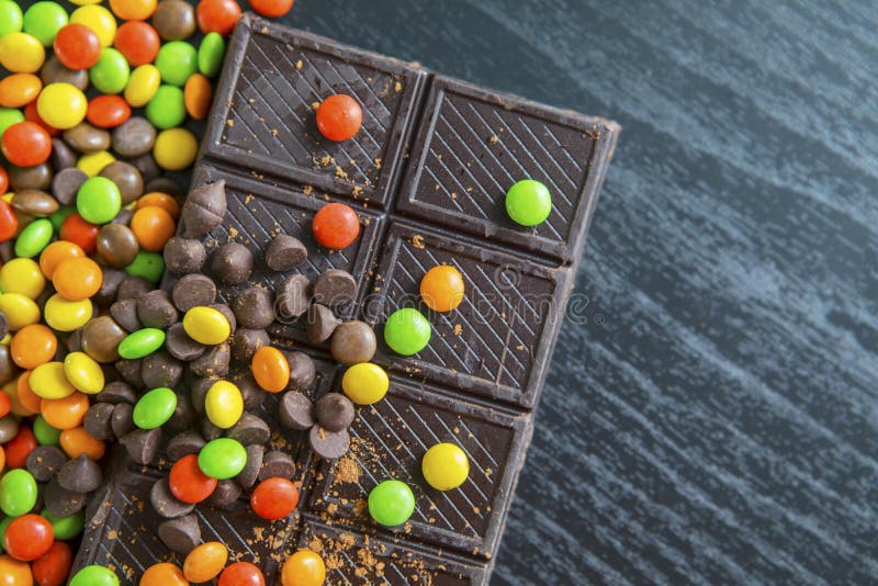 Colored Candies with a Chocolate Bar on the Table Stock Image - Image ...