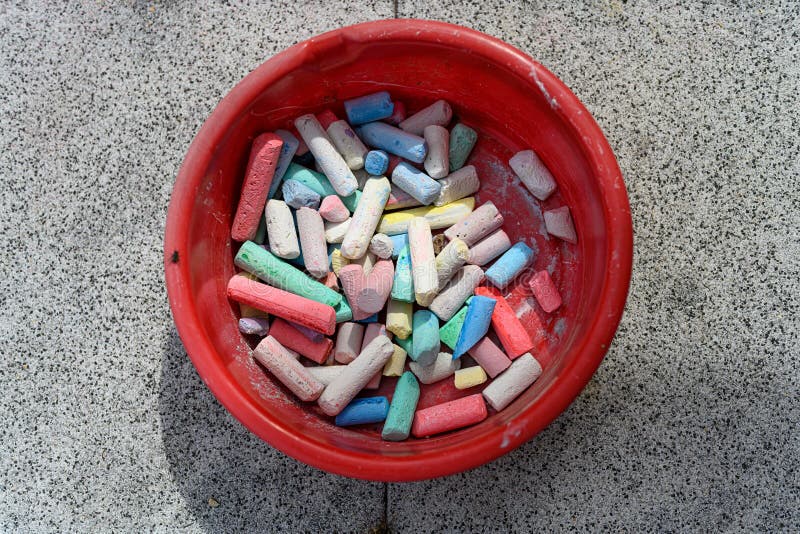 A Red Bucket Full of Chalk Colors on a Gray Background Stock Photo ...