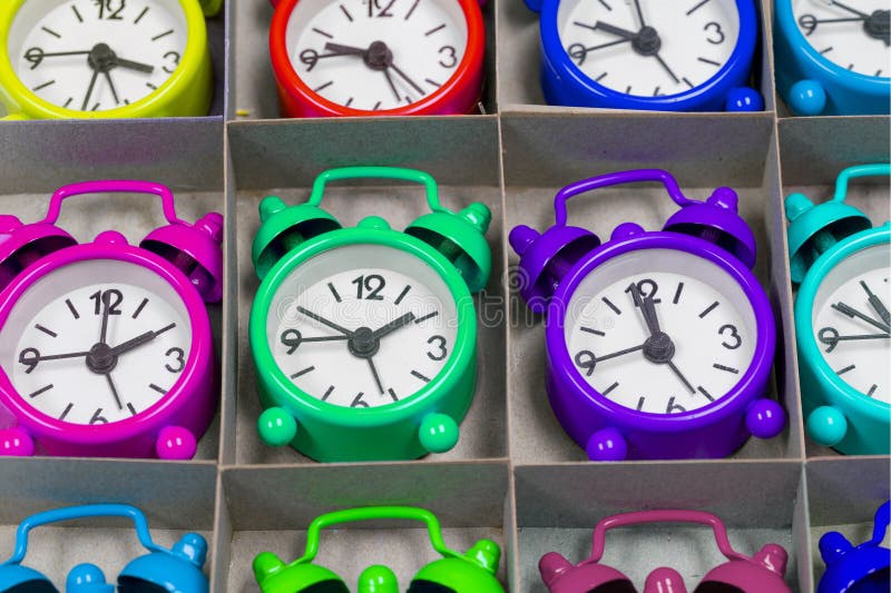 Colored Clock Alarm Clocks in a Cardboard Box Stock Image - Image of ...