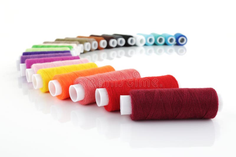 Colored Cotton Reels in an Arc on White with Shallow Depth of Field ...