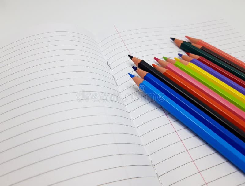 Colored Crayons on Notebook Background Stock Photo - Image of crayon ...