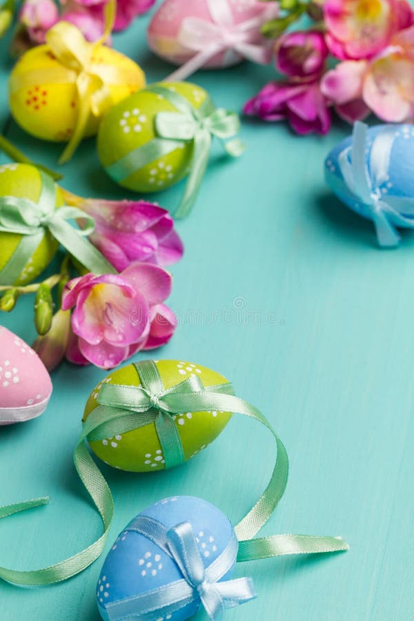 Colored Easter Eggs with Ribbons and Flowers on a Turquoise Table Stock ...