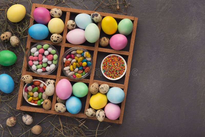 Colored Easter Eggs and Small Candies in Frame on Gray Background Stock ...
