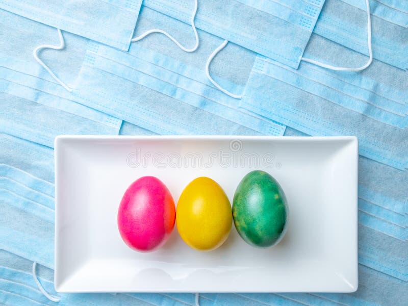 Colored Easter Eggs on a White Plate on a Background of Blue Medical ...
