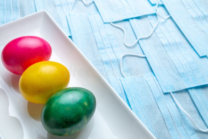Colored Easter Eggs on a White Plate on a Background of Blue Medical ...
