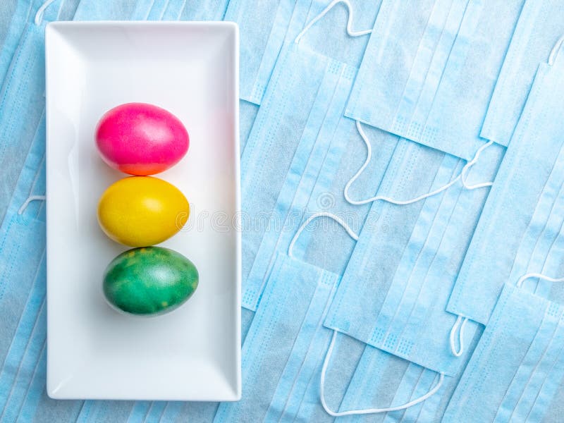 Colored Easter Eggs on a White Plate on a Background of Blue Medical ...