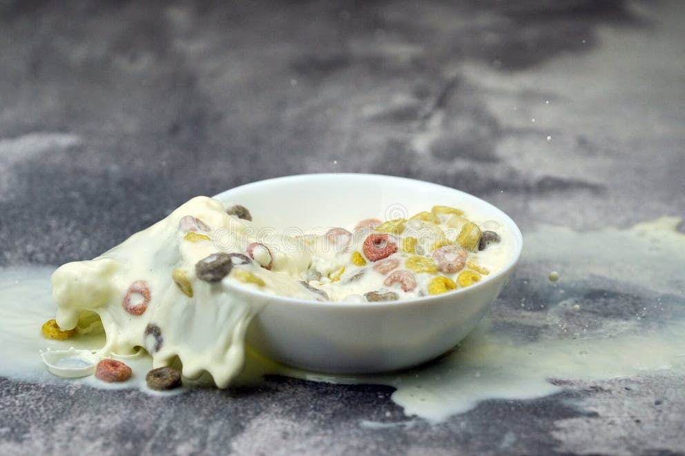 Colored Fruit Loops with Milk in a Bowl. Pouring Milk into a Bowl Stock ...