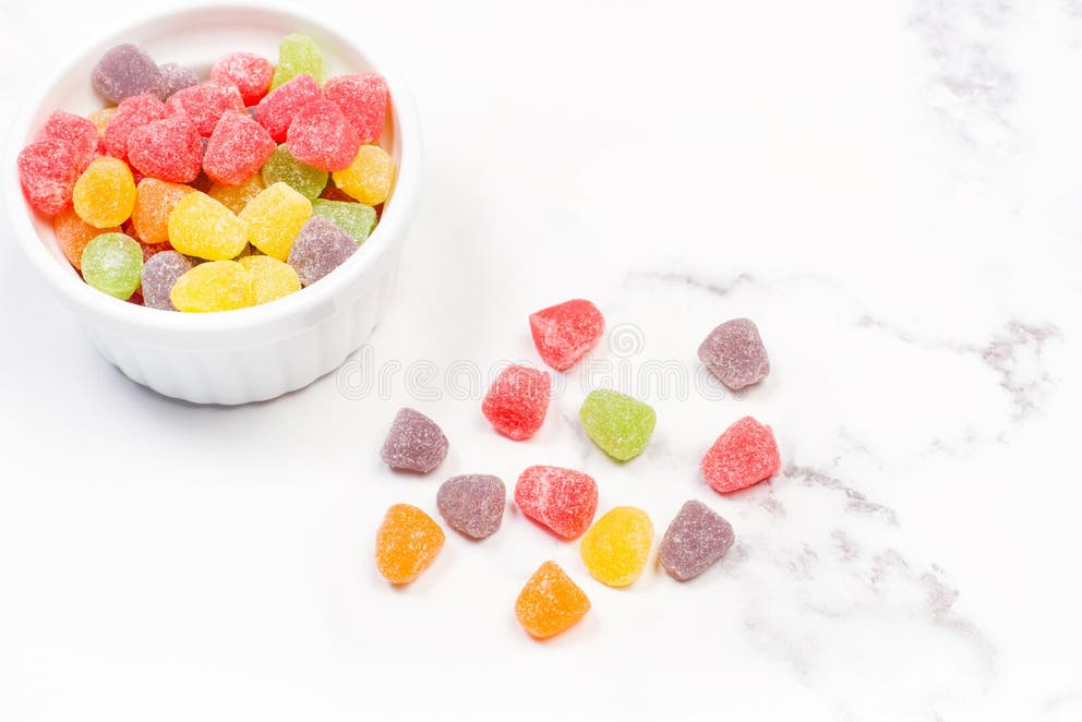 Colored Gummies in a White Bowl and on a Marble Kitchen Counter Stock ...