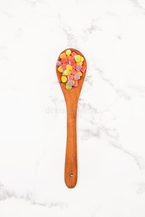 Colored Gummies on a Wooden Spoon on a Marble Kitchen Counter Stock ...