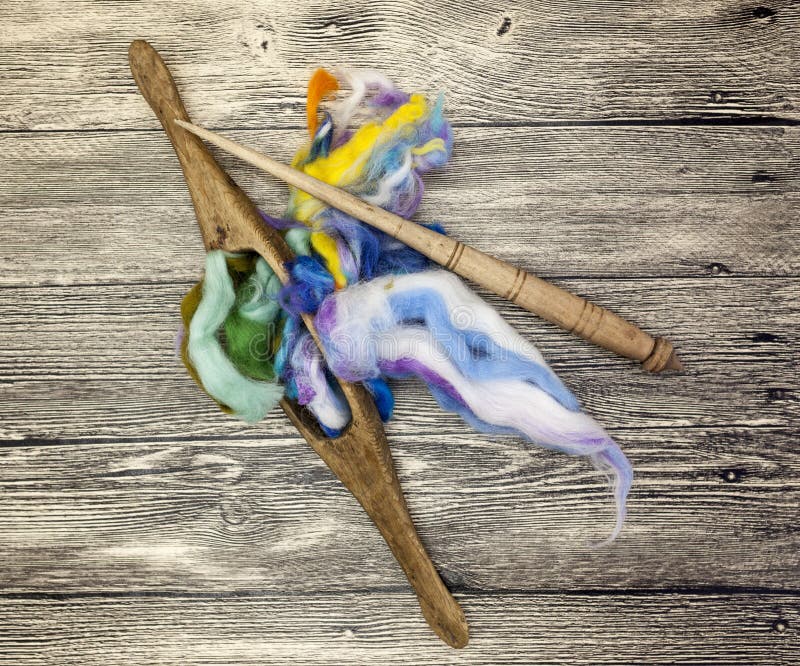 Colored Hair and Old Spindle Close-up on Wooden Background. Tools for ...