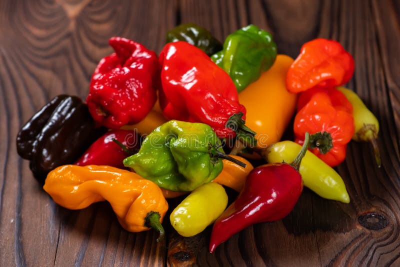 Colored Hot Peppers on a Wooden Surface Stock Image - Image of colored ...