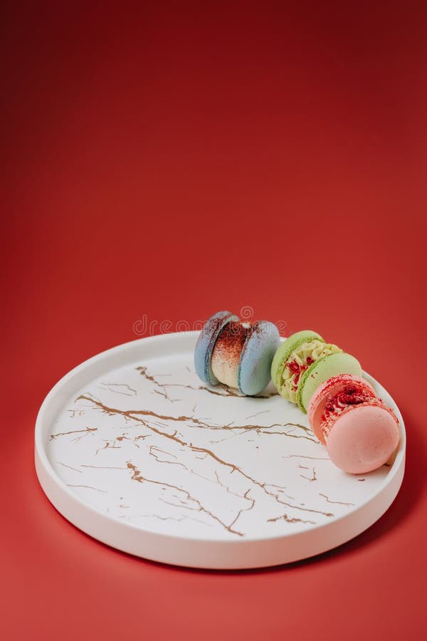 Colored Large Macaroons on a Black Plate, with Various Fillings. on a ...