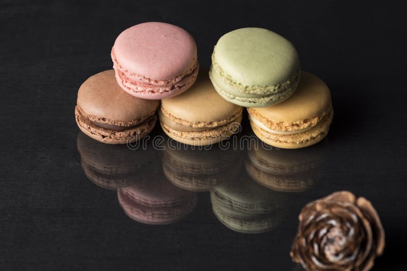 Colored Macarons on a Black Surface and with Stock Photo - Image of ...