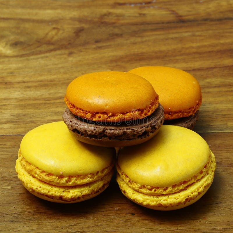 Colored Macaroons on Wooden Table Stock Photo - Image of orange, yellow ...