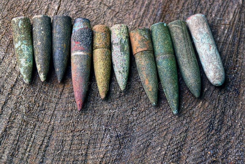 Set of Old Colored Bullets on a Wooden Board Stock Image - Image of ...