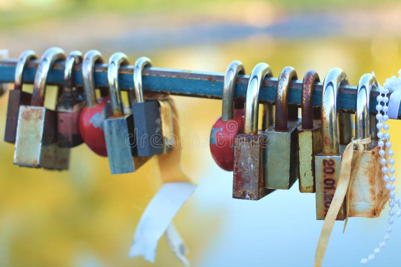 Colored Padlocks on the Railing of the Bridge Over the River Stock ...
