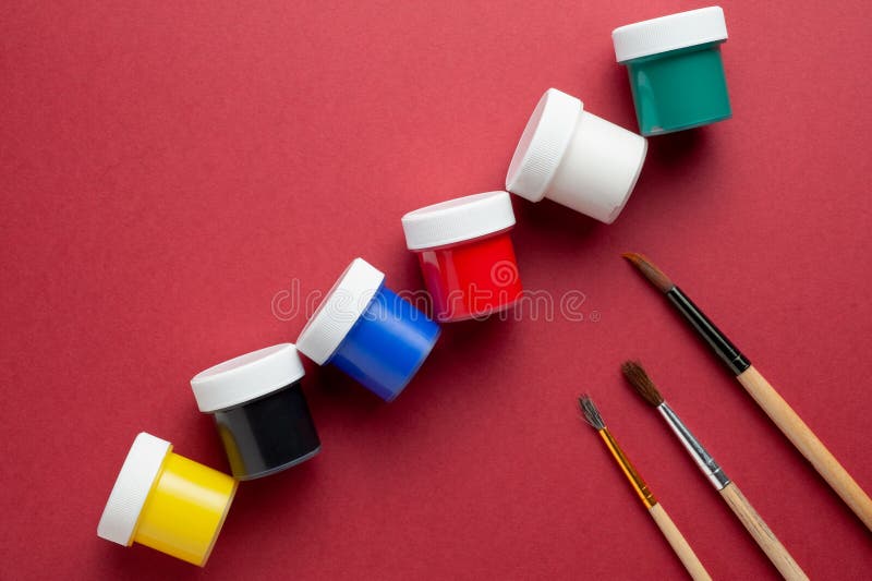 Colored Paints and Brushes Lie on a Red Background, Objects for ...