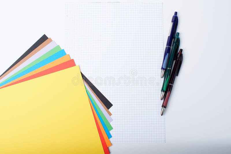 Colored Paper, Checkered Sheets and Three Pens. Isolate Stock Photo ...