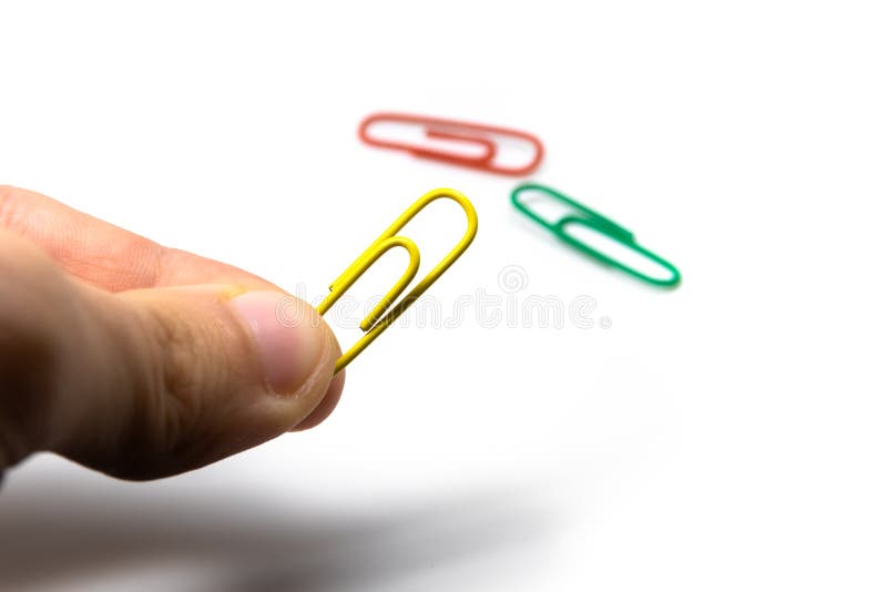 Colored Paper Clips in Hand on White Isolated Background Stock Photo ...