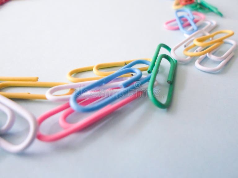 Colored Paper Clips on a White Sheet of Paper Scattered. Side View ...