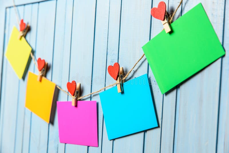 Colored Paper Sheets on Thread with Heart Shaped Clothespin Blue Wooden ...