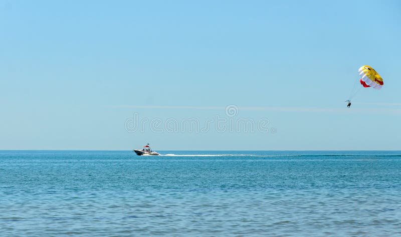 Colored Parasail Wing Pulled by a Boat in the Sea Water, Parasailing ...