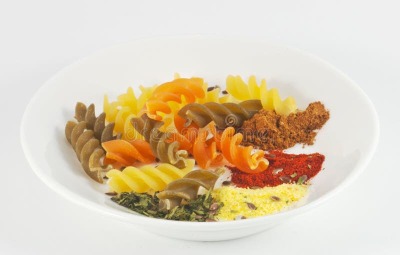 Colored pasta on the plate stock image. Image of gourmet - 22939143