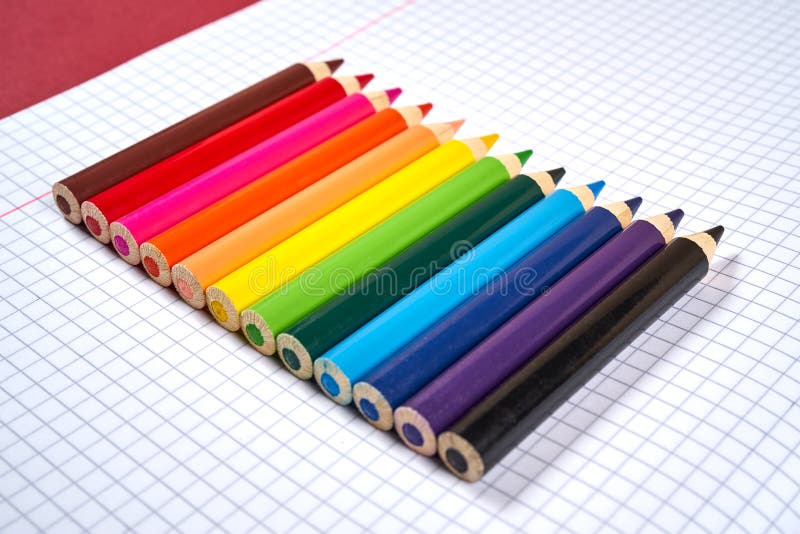 Colored Pencil Crayons on an Open Checkered Notebook Stock Image ...