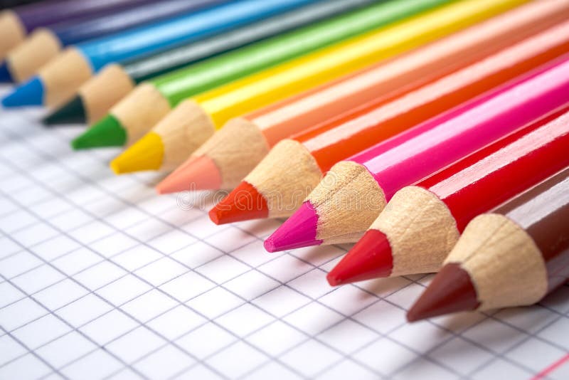 Colored Pencil Crayons on an Open Checkered Notebook Stock Image ...