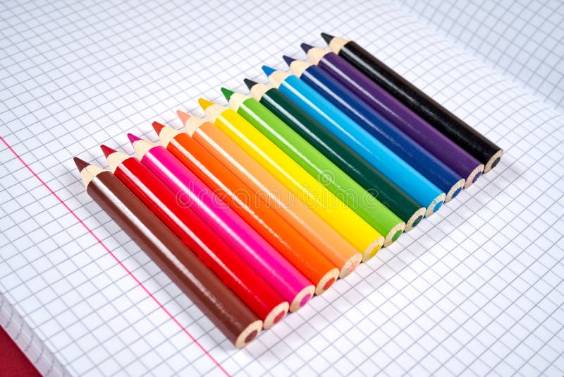 Colored Pencil Crayons on an Open Checkered Notebook Stock Photo ...
