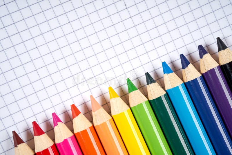 Colored Pencil Crayons on an Open Checkered Notebook Stock Photo ...