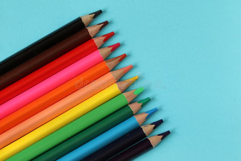 Colored Pencils on Blue Paper Background. Stock Photo - Image of ...