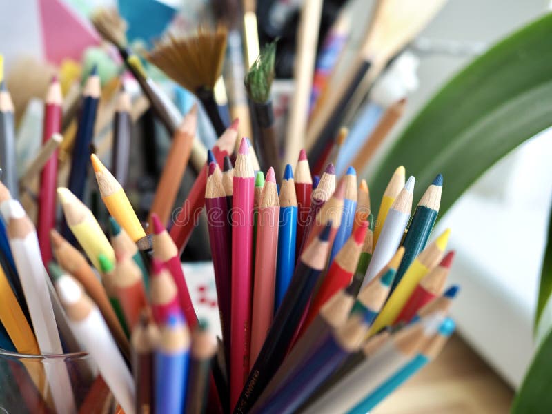 Colored Pencils are in a Glass on the Table in a Creative Mess Stock ...