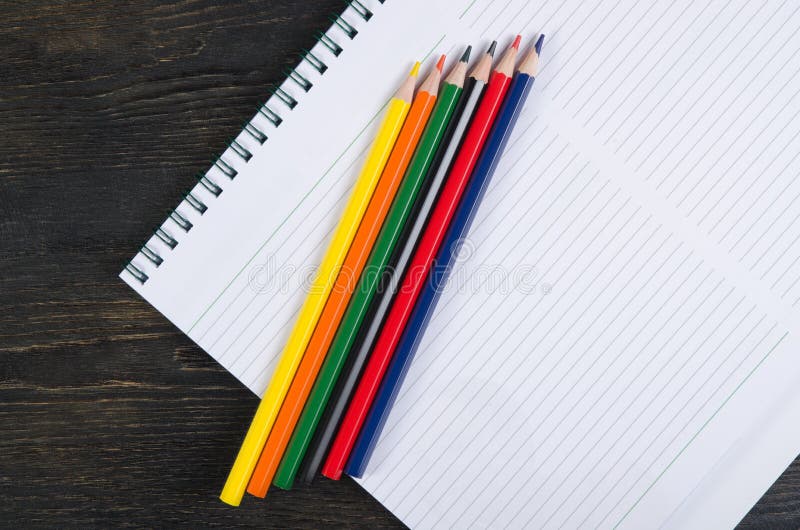 Colored Pencils and a Notebook Stock Photo - Image of notepad, eraser ...