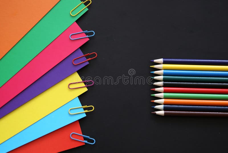 Colored Pencils in a Row on a Black Sheet of Paper Stock Image - Image ...