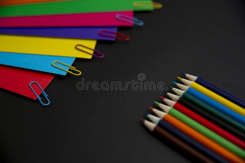 Colored Pencils in a Row on a Black Sheet of Paper Stock Image - Image ...