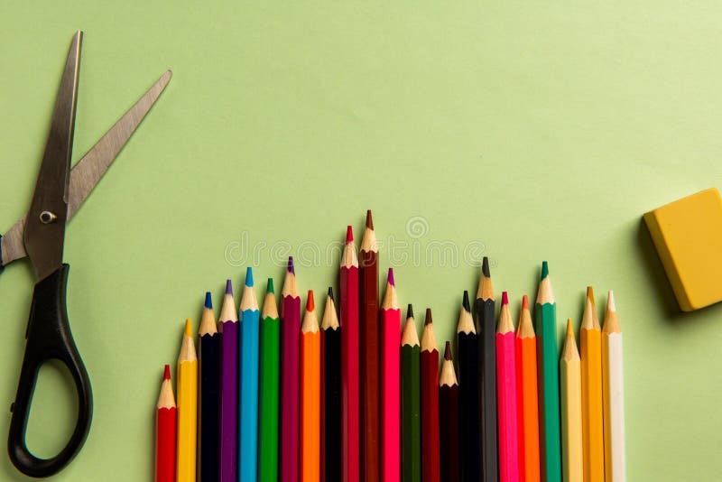 Colored Pencils, Scissors and Eraser Lie on Colored Paper Stock Photo ...