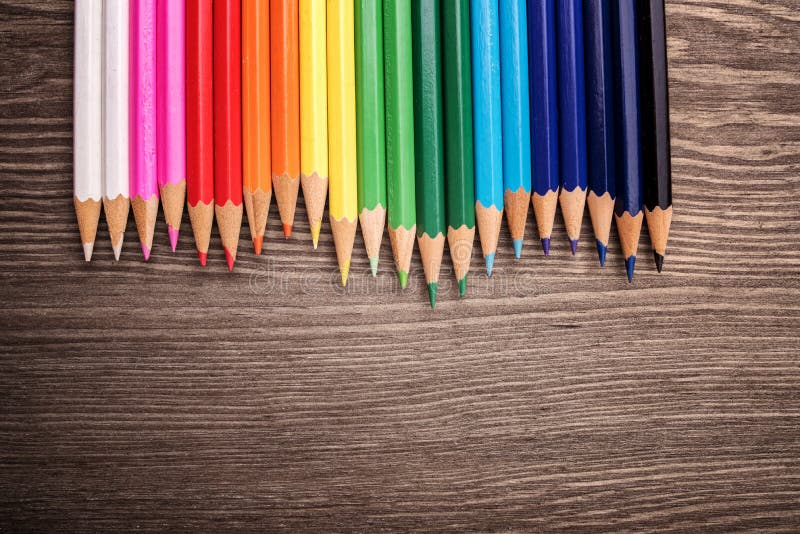 Colored pencils on table stock image. Image of drawing - 140212717