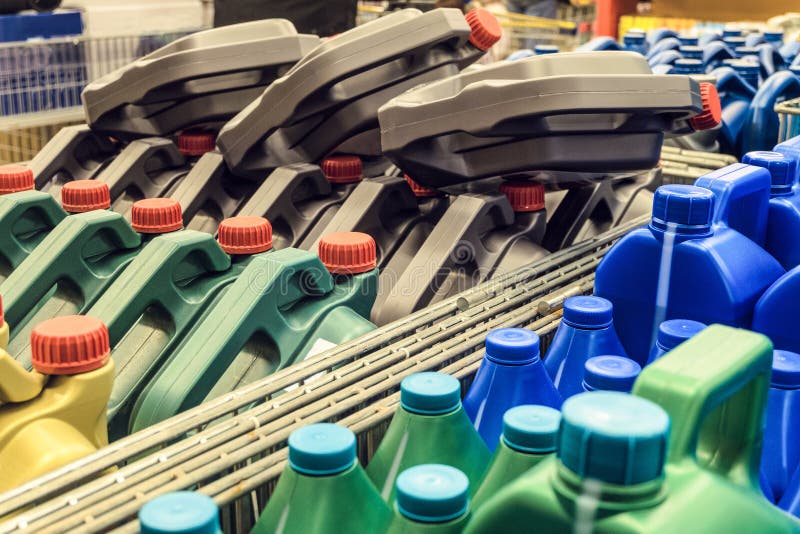 Colored Plastic Cans with Engine Oil. Canisters on a Pallet Stock Photo ...