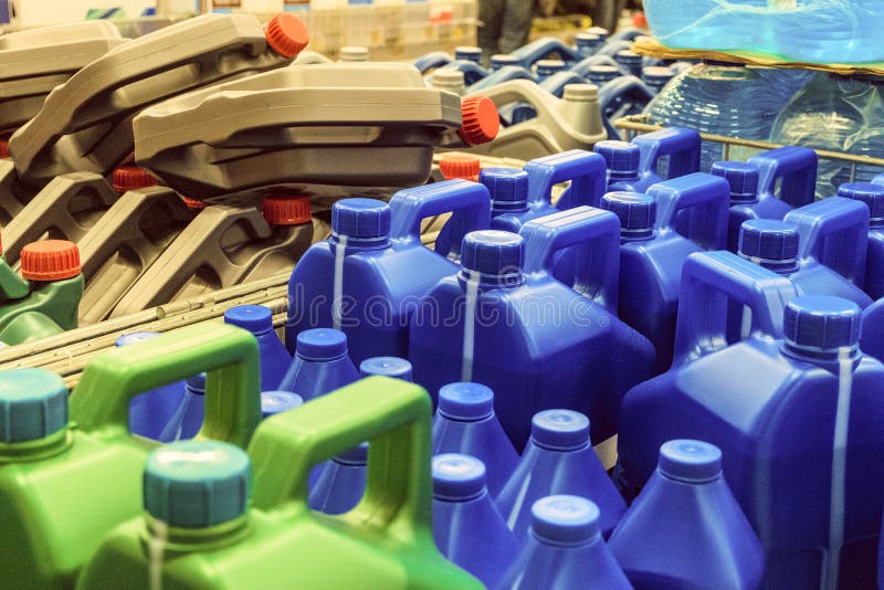 Colored Plastic Cans with Engine Oil. Canisters Placed on a Pallet ...