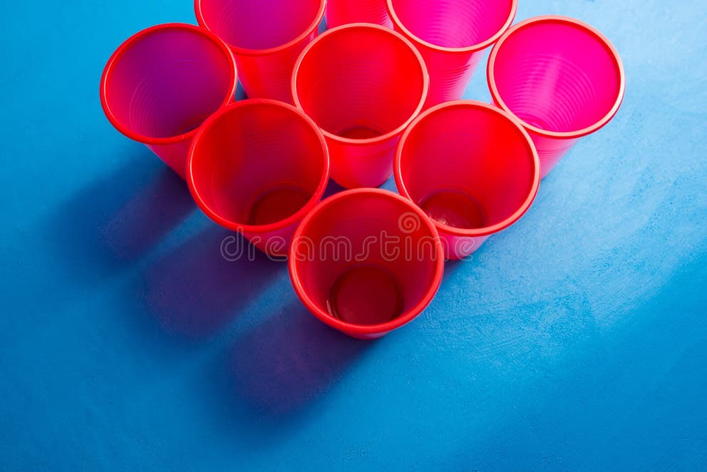 Colored Plastic Cups are a Triangle on a Blue Background. Composition ...