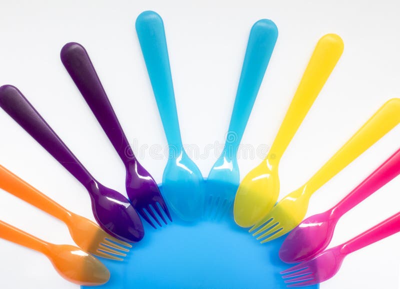 Colored Plastic Forks and Spoons , on a Plate, the Background on Stock ...
