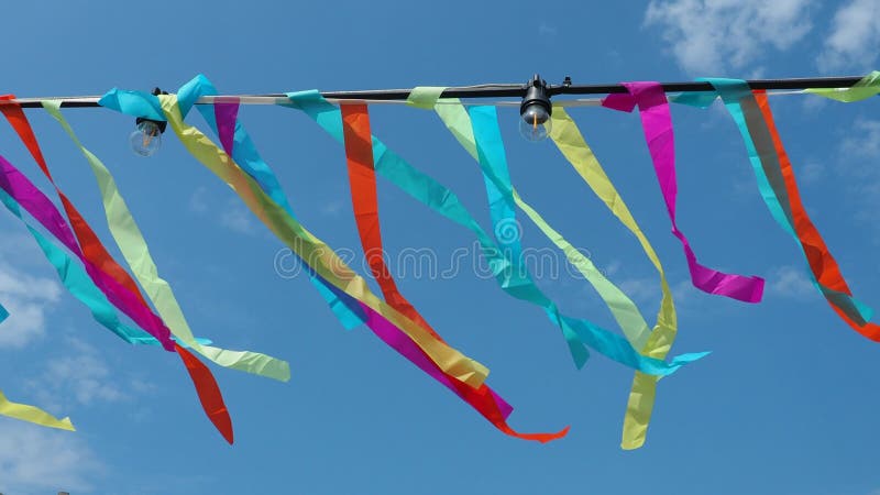 Colored Ribbons Flutter in the Wind. a Blue Sky with Clouds Stock ...