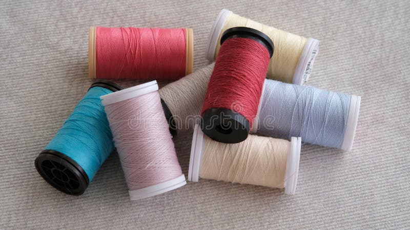 Colored Sewing Thread Reels on Fabric Stock Photo - Image of fabric ...