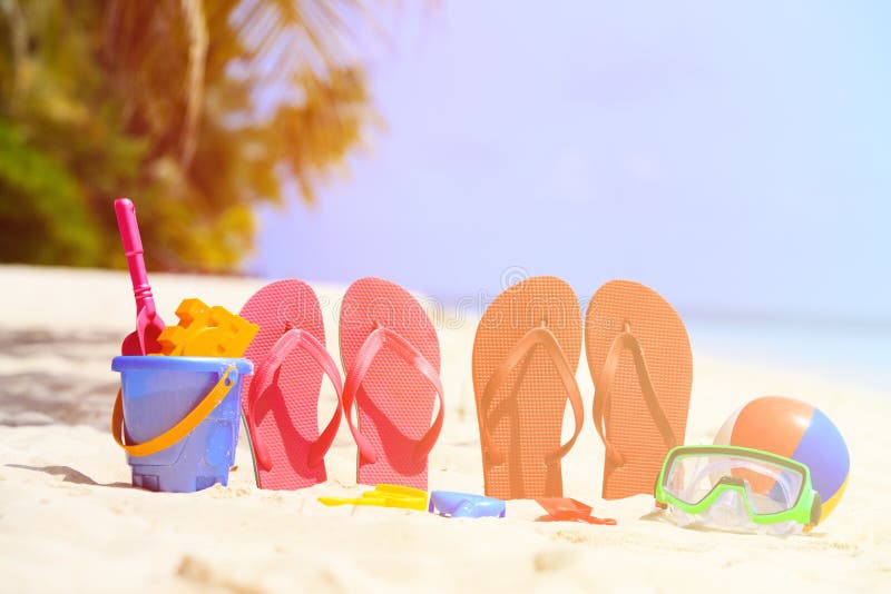 Colored Slippers, Toys and Diving Mask at Beach Stock Photo - Image of ...