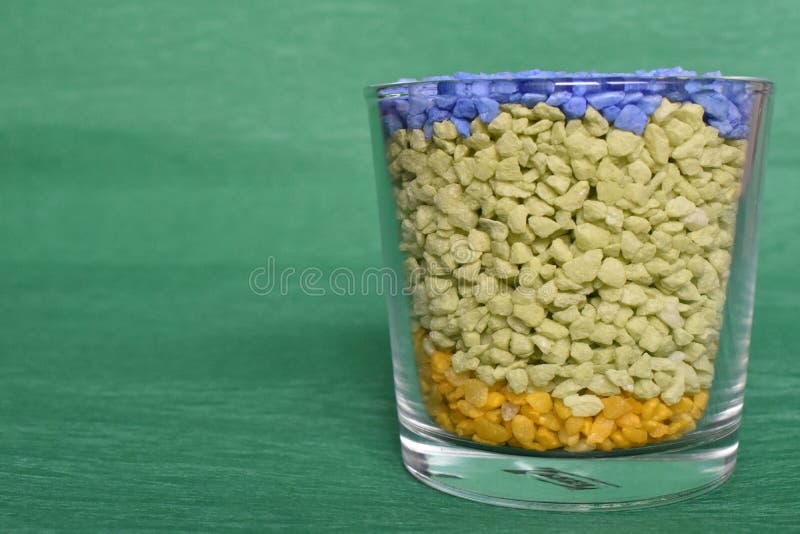 Colored Small Rocks in the Glass on the Green Background Stock Photo ...