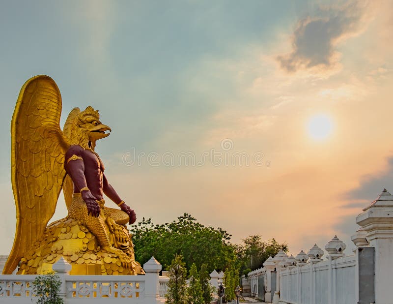 Colored Statue of Eagle God or Garuda with Beautiful Sky of Senset Time ...