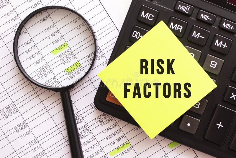 A Colored Sticker with the Text RISK FACTORS Lies on the Calculator ...