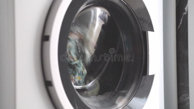 Colored Things are Washed in Washing Machine, Process is Visible ...